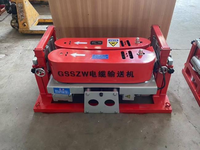 Close-up view of GSSZW Cable Pulling Machine's conveyor system and controls