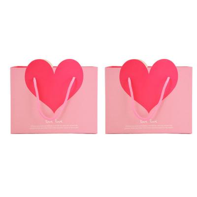 China heart-shaped pink promotional beverage handbag custom printing available gift paper bags for sale