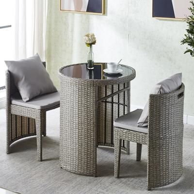 China Rattan Tempered Glass Round Dining Table and Chair Set for Coffee Shop Modern Design for sale
