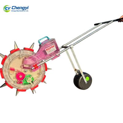 China Rust Resistant Steel Hand Push Seeder With Adjustable 15-30cm Row Spacing for sale