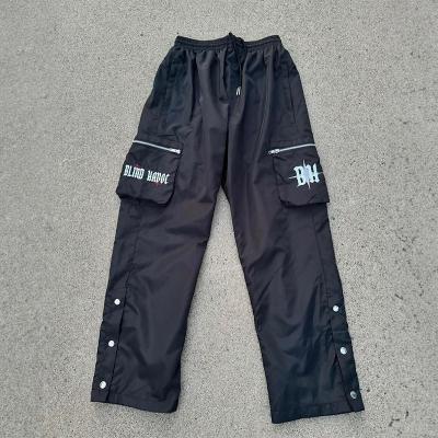 China Custom Nylon Screen Print Outdoor Cargo Pants Windbreaker Lightweight Zipper Pocket Sweatpants Side Hem With Button up Collar for sale