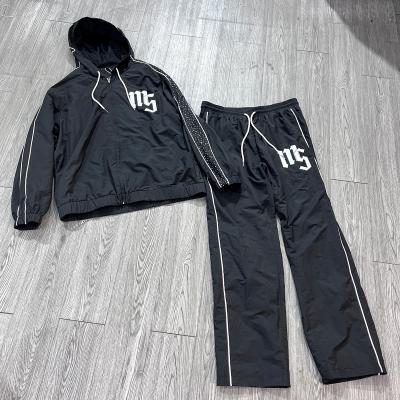 China Custom Windbreaker Hoodie Jacket In Nylon Fabric With Screen Print Logo And Reflective Rhinestone Patches for sale