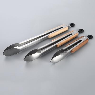 Cina Clip di legno termoresistente dell'alimento del barbecue della maniglia di acciaio inossidabile delle tenaglie dell'alimento della cucina in vendita