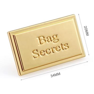 China Engraved Logo Metal Name Plate Golden Professional Design Custom Metal Logo Labels For Handbags Te koop
