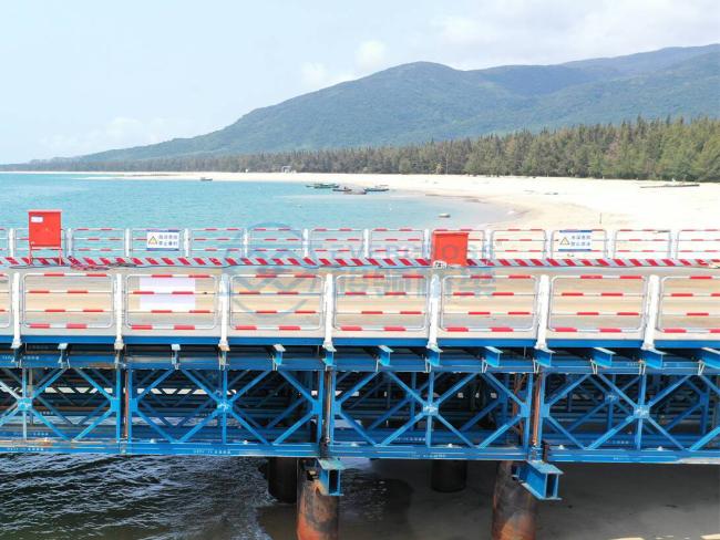 Bailey trestle bridge supporting heavy equipment installation at industrial site