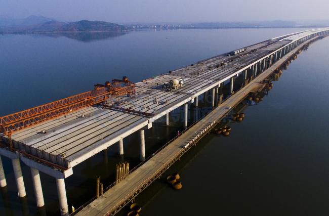 Trestle bridge supporting heavy equipment installation in industrial setting