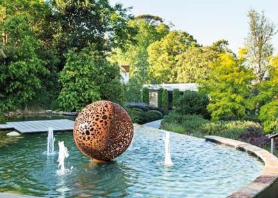 China Rusty Corten Steel Hollow Ball Sculpture For Garden for sale