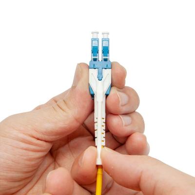 Cina 5 metri LC/LC - UPC - Monomodale - Uniboot con Pull Push Tab- Cavo patch in fibra ottica OFNR duplex in vendita