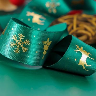 China 25mm Green Satin Ribbon with Christmas Tree Deer and Snowflake Gold Print 100 Yards Roll for sale