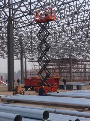 China Electric Scissor Lift  GTJZ1212 with 12m Lifting Height  0.9m Extension Outreach, Capacity 320kg and 25% Gradeability for sale