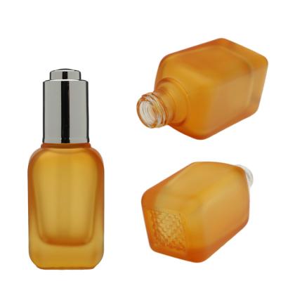 China Custom Square Cosmetic Glass Bottle 50ml Flat Shoulder Push Button Dropper Bottle for sale