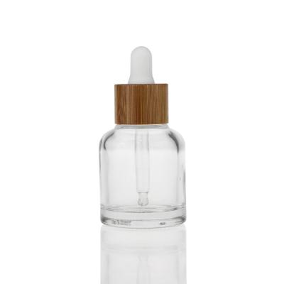 China Cosmetic Skincare Glass Serum Bottle 20ml 30ml 50ml With Bamboo Collar Cap for sale