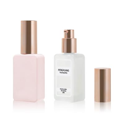 China Custom pink 35ml glass foundation bottle wholesale gold lotion pump square skin care packaging glass cosmetic foundation for sale