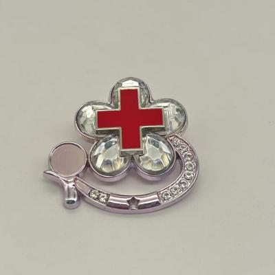 China Premium Metal Nurse Badge: Red Cross & Clover Design with Crystal Inlay for sale