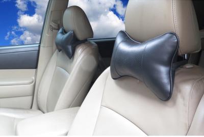 China hot sell dog bone shape PU leather black color car truck neck pillow for sale