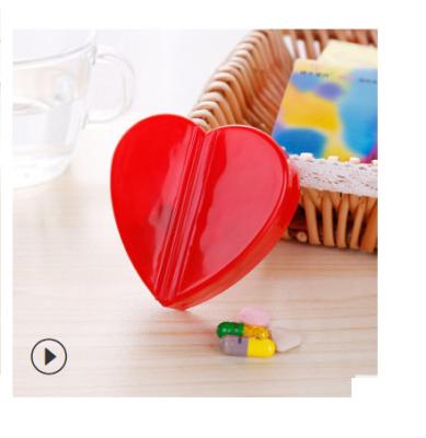China Can rotation Cute Heart shape pill box with four compartments  and can changed it with oval shape  pill holder for sale