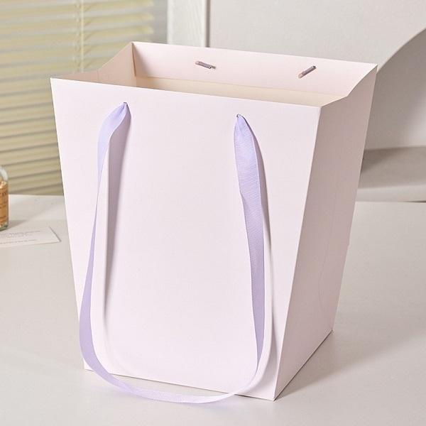 Lilac purple trapezoidal paper flower bag with soft matching ribbon handles