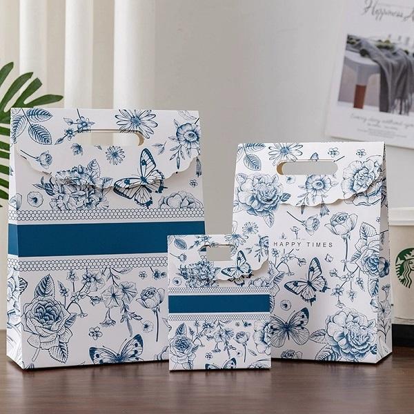 Quality Floral Printed Paper Gift Bags with Die Cut Handle and Flap Top for sale