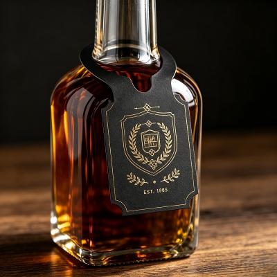 China Black Vellum Paper Liquor Neck Tag With Gold Foil For Bottle Packaging for sale