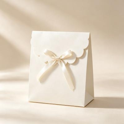 China Aesthetic Scalloped Flap Gift Bags For Wedding And Party Favors for sale
