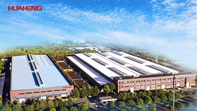 Aerial drone view of a large-scale HUAHENG manufacturing base with production workshops
