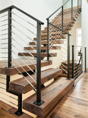 China Carbon steel center stringer L-shape solid wood staircase with glass railing for sale