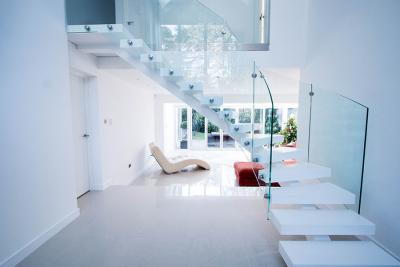 China Interior white color curved staircase with glass railing design for sale