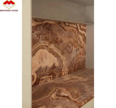 Cina Marmo di onice rosso tigre naturale trasparente lucidato per il design dell'hotel di giada retroilluminato moderno in vendita