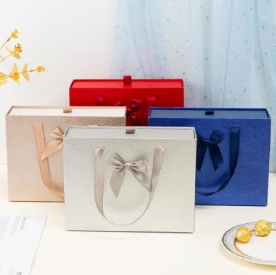 China CMYK Printing Cardboard Gift Bag Matte Glossy Surface With Drawer Box Bow for sale