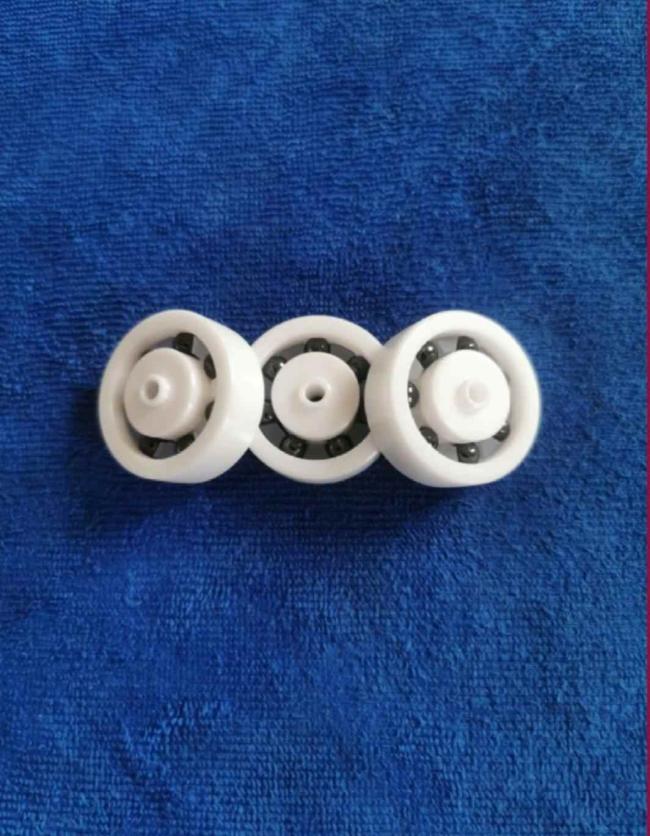 Multiple ceramic ball bearings displayed on industrial background