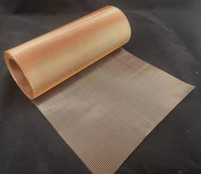 Close-up view of expanded brass mesh showing diamond-shaped openings