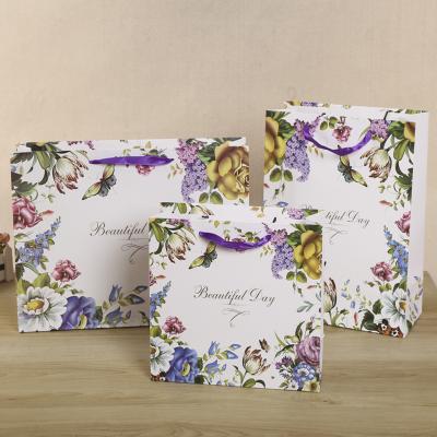 China bolsas de papel publicitarias de gran tamaño personalizadas con asa de cinta para paquete en venta