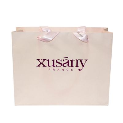 China Custom Luxury Paper Carrier Gift Bags Wholesale Design Print with Red Foil Logo for sale