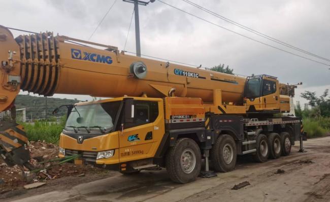 XCMG QY110K8C mobile crane in operation showing full boom extension