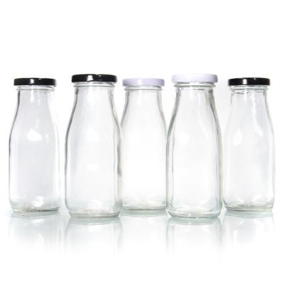 China OEM Kombucha Glass Milk Bottles Glass Juice Containers With Lids for sale