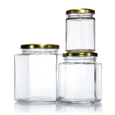 China Food Grade Empty Clear Hexagonal Square Glass Empty Food Storage Jars for sale