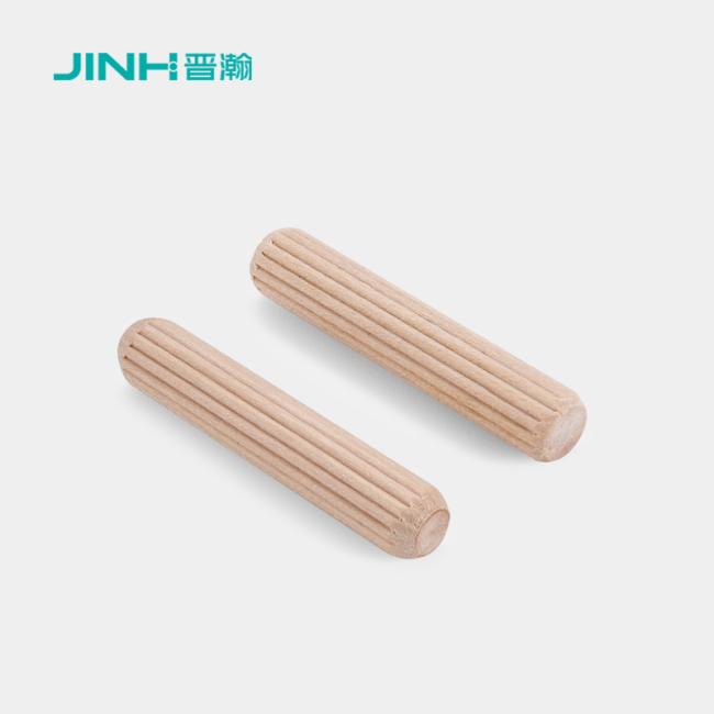 Close-up view of JINHAN wooden dowel pins showing fluted design