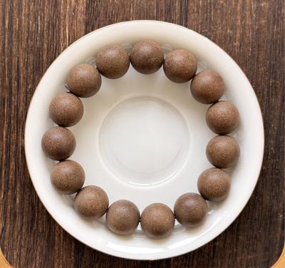 China Buddhist Brown Wood Bracelet Twelve Medicinal Ingredients Aiding Sleep Agarwood Beads for sale
