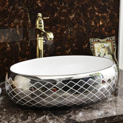China Bathroom ceramic slivery modern oval luxury design hot selling tabletop wash basin sink with standard size in inch for sale
