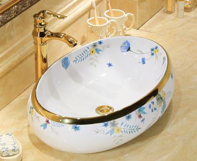 China Hot selling bathroom tabletop golden hand painted ceramic oval wash art basin sink from chaozhou china manufacturer for sale