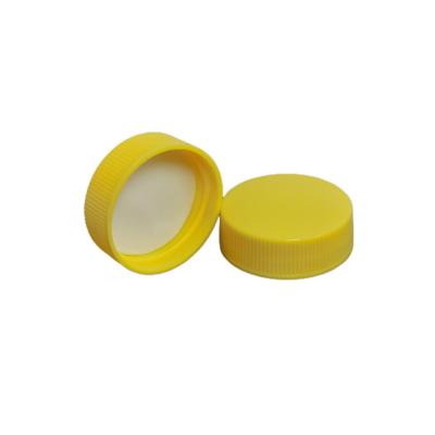 China 24/410 38-400 Ribbed Yellow Polypro Caps w/ Pressure Sensitive Liners for sale