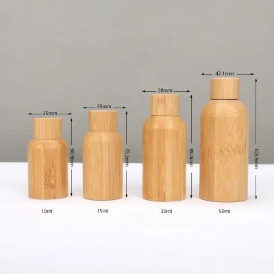 中国 15ml 30ml 50ml Empty  Bamboo Cosmetic Essential Oil Glass Bottle Screaw Cap 販売のため