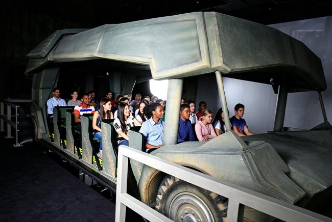 Interior view of the 30-seat motion theater with panoramic screen and comfortable seating