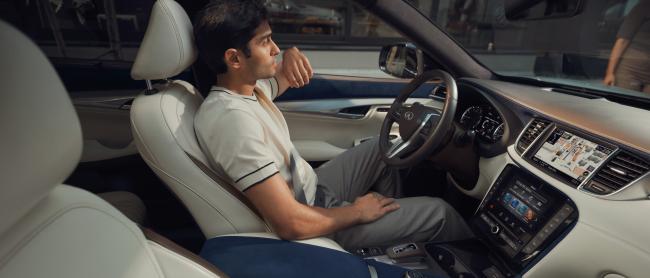 Driver in the 2024 INFINITI QX50 compact SUV