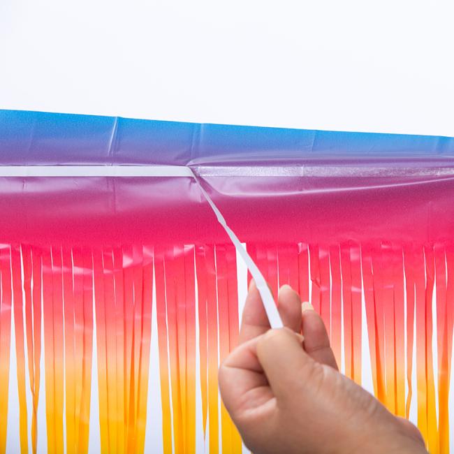 Vibrant Macaron Foil Fringe Curtain displayed as wall decor