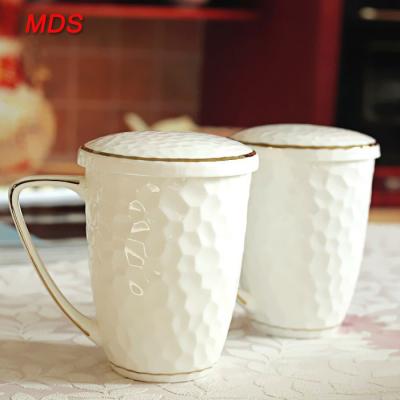 China Creative water cube embossed bone china mug with gold rim and lid for sale