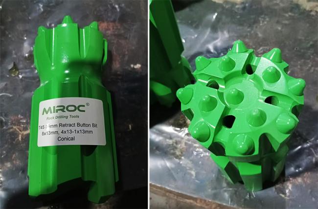 Retract drill button bit close-up showing carbide buttons and grooves