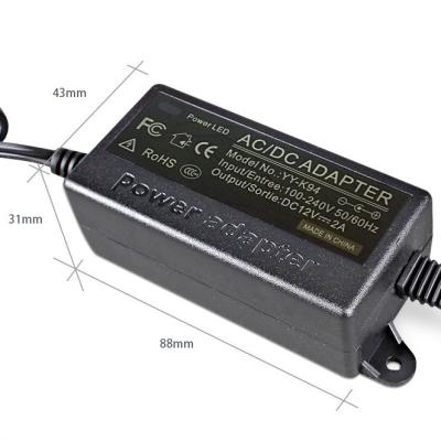 China Black C-Power AC100-240V DC 12V 2A Adaptador de alimentação de tomada montado na parede 12Volt para UE AU Reino Unido EUA à venda