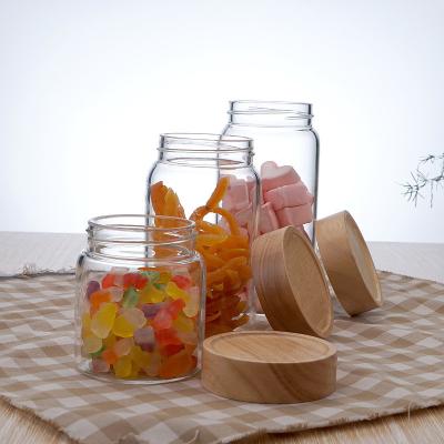 Cina I barattoli di vetro vuoti dell'alto borosilicato ventilano i contenitori stretti dei barattoli di stoccaggio con il coperchio di legno in vendita