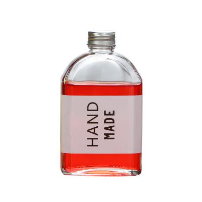 Cina bottiglia di vetro spessa della bottiglia di vino di 350ml Juice Glass Drinking Bottles Flat con il coperchio in vendita